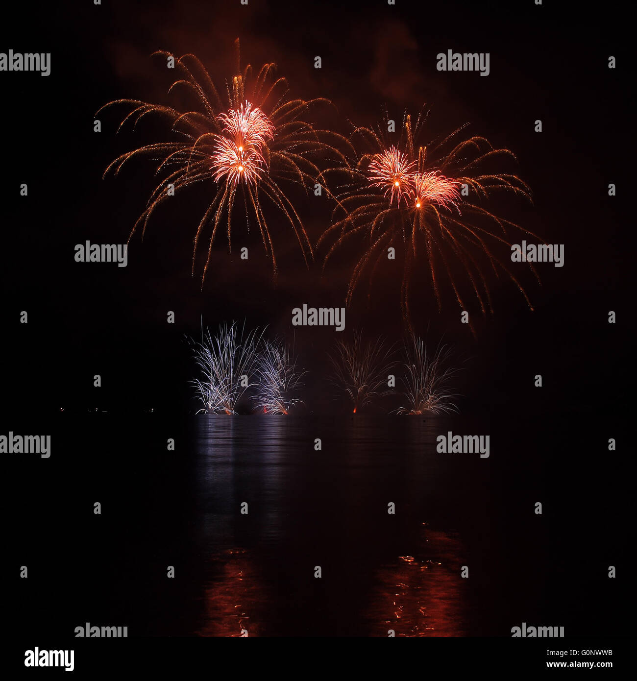 Colorful fireworks with reflection on lake and night sky in background ...