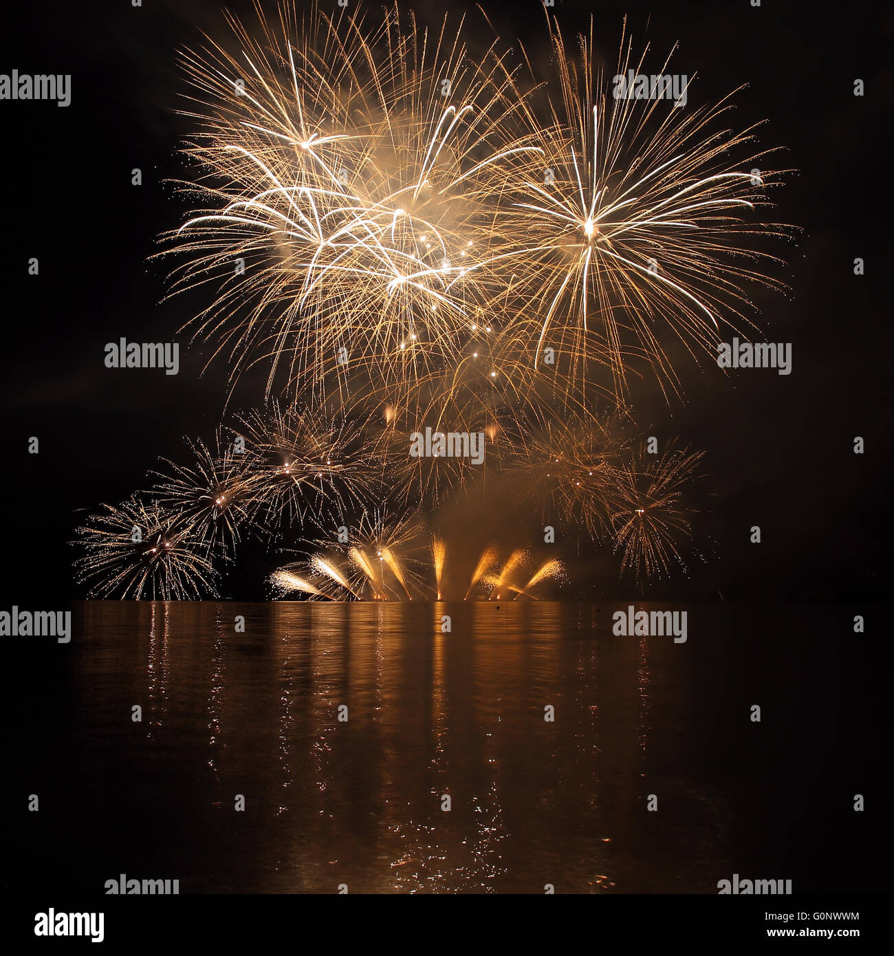 Colorful fireworks with reflection on lake and night sky in background ...