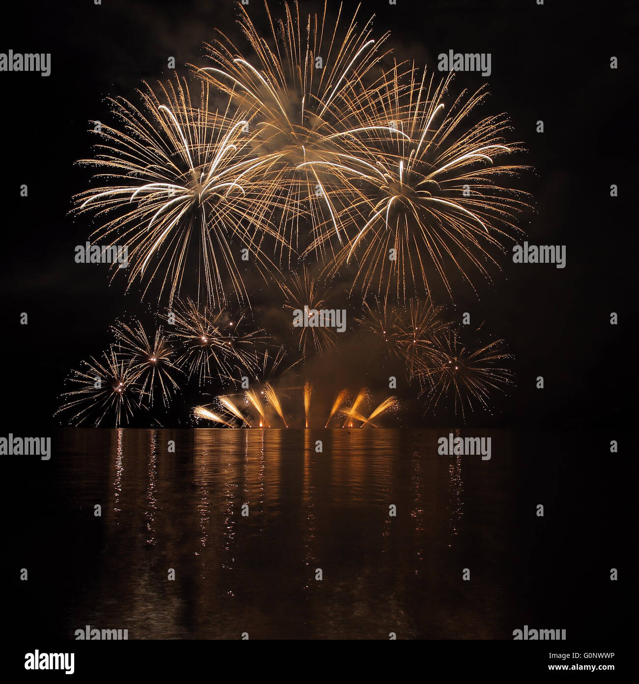 Colorful fireworks with reflection on lake and night sky in background ...