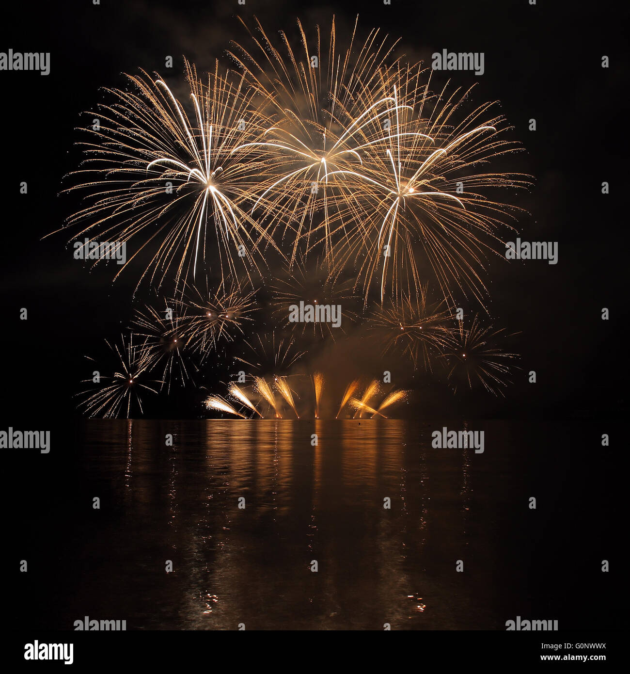 Colorful fireworks with reflection on lake and night sky in background ...