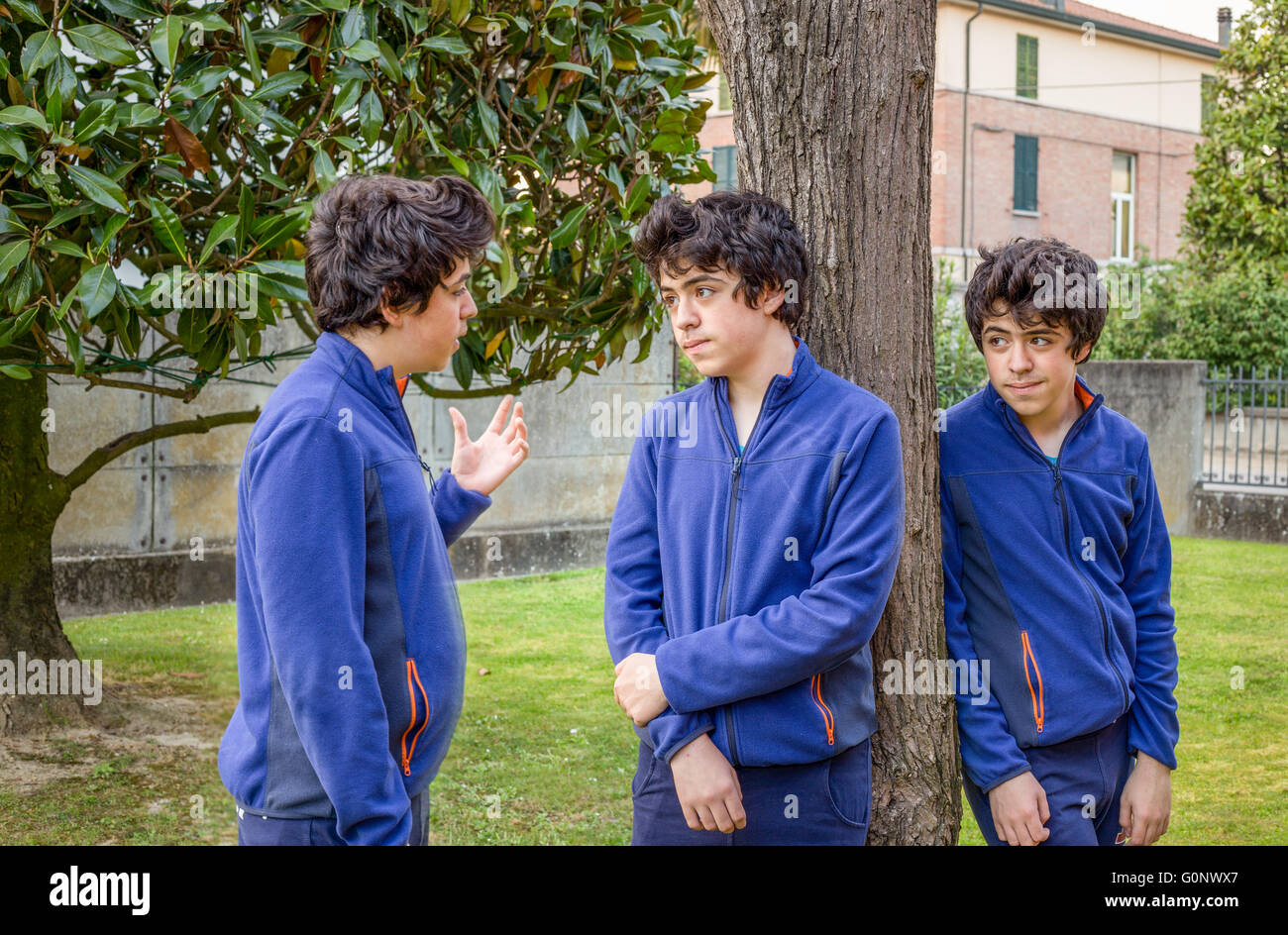 Three boys talking hi-res stock photography and images - Alamy