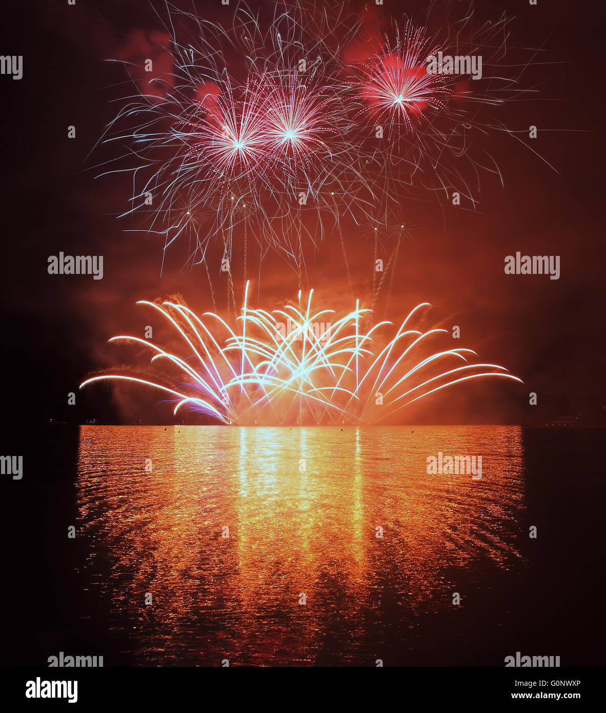 Colorful fireworks with reflection on lake and night sky in background ...