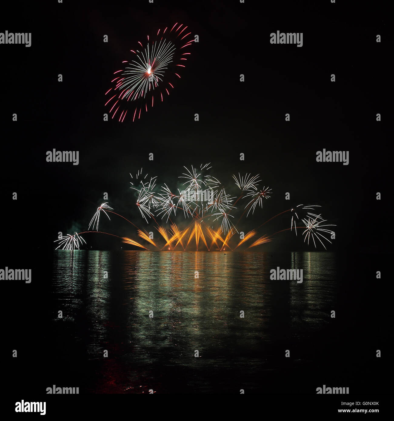 Colorful fireworks with reflection on lake and night sky in background ...