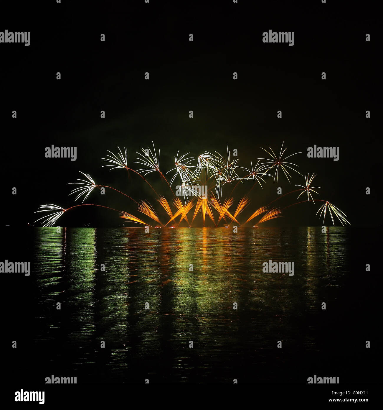 Colorful fireworks with reflection on lake and night sky in background ...