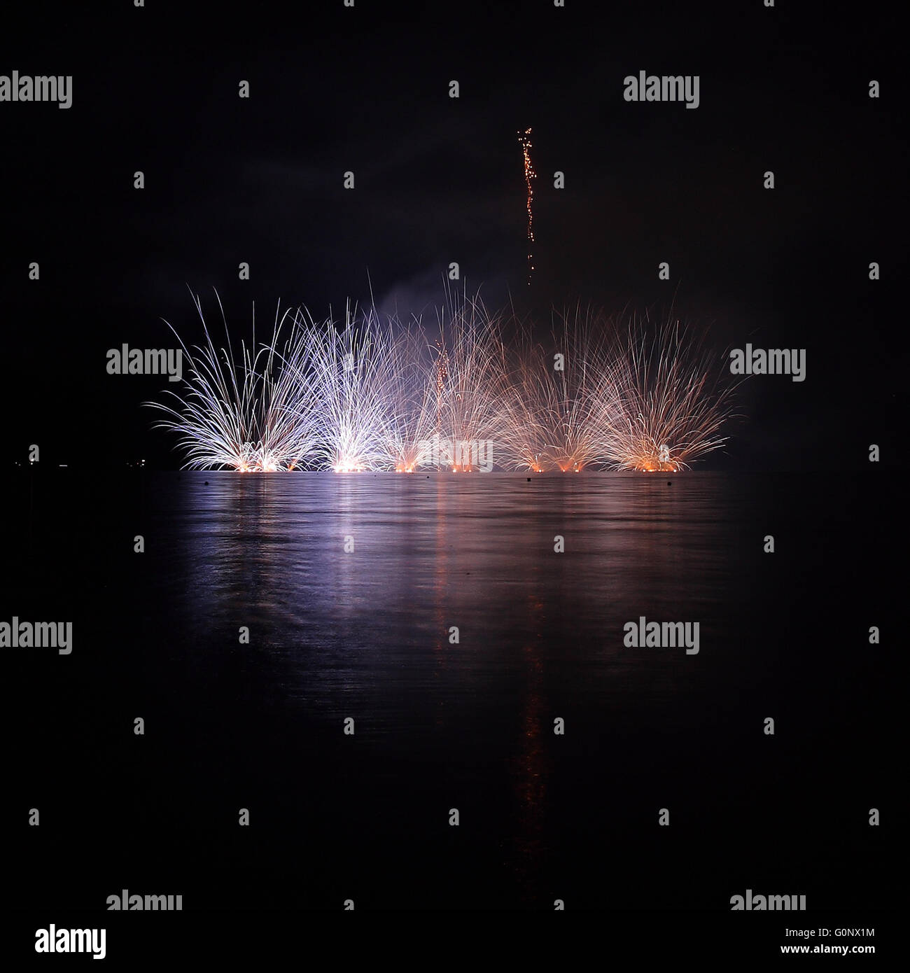 Colorful fireworks with reflection on lake and night sky in background ...