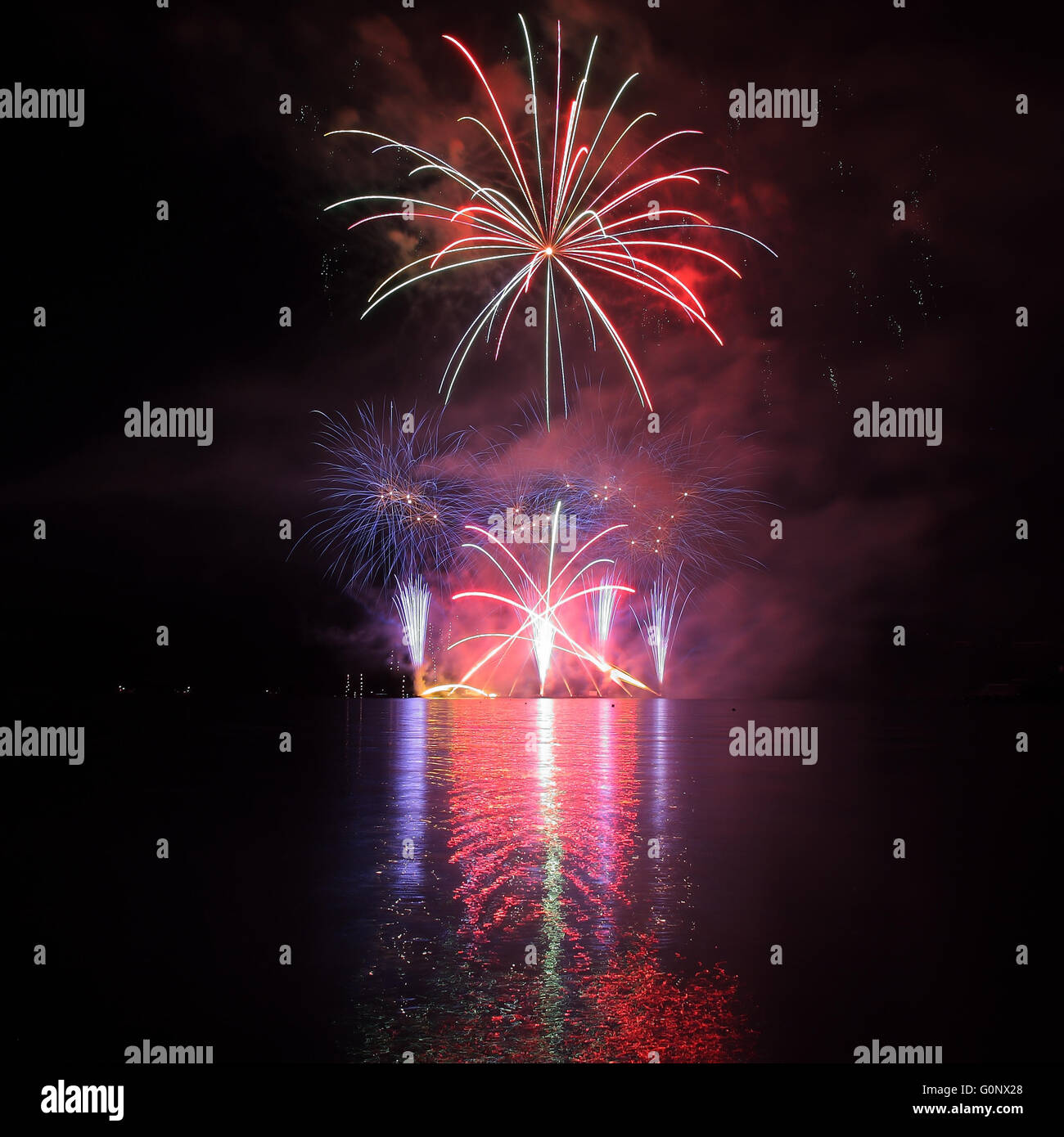 Colorful fireworks with reflection on lake and night sky in background ...