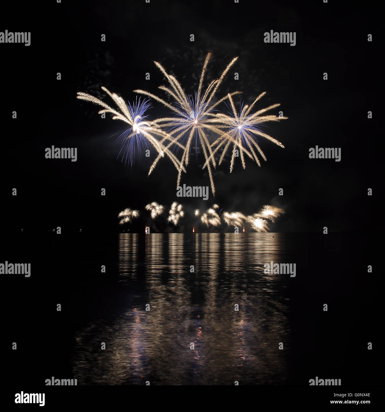 Colorful fireworks with reflection on lake and night sky in background ...