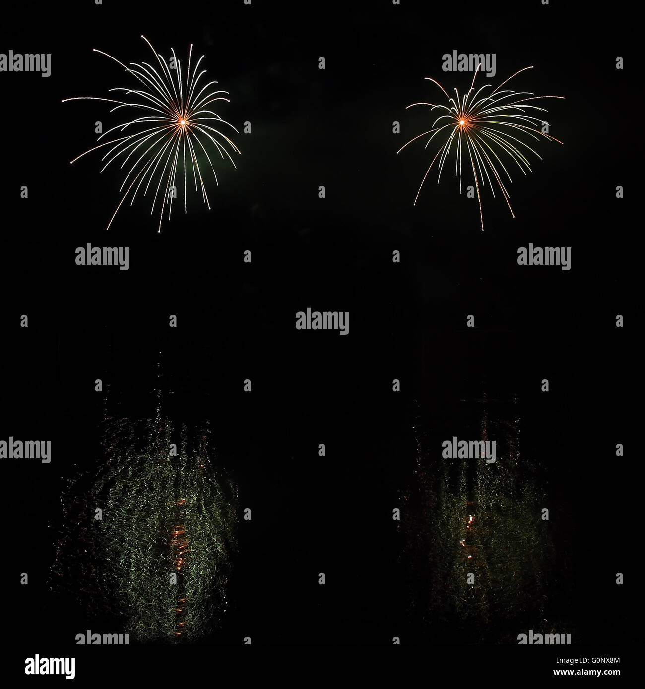 Colorful fireworks with reflection on lake and night sky in background ...