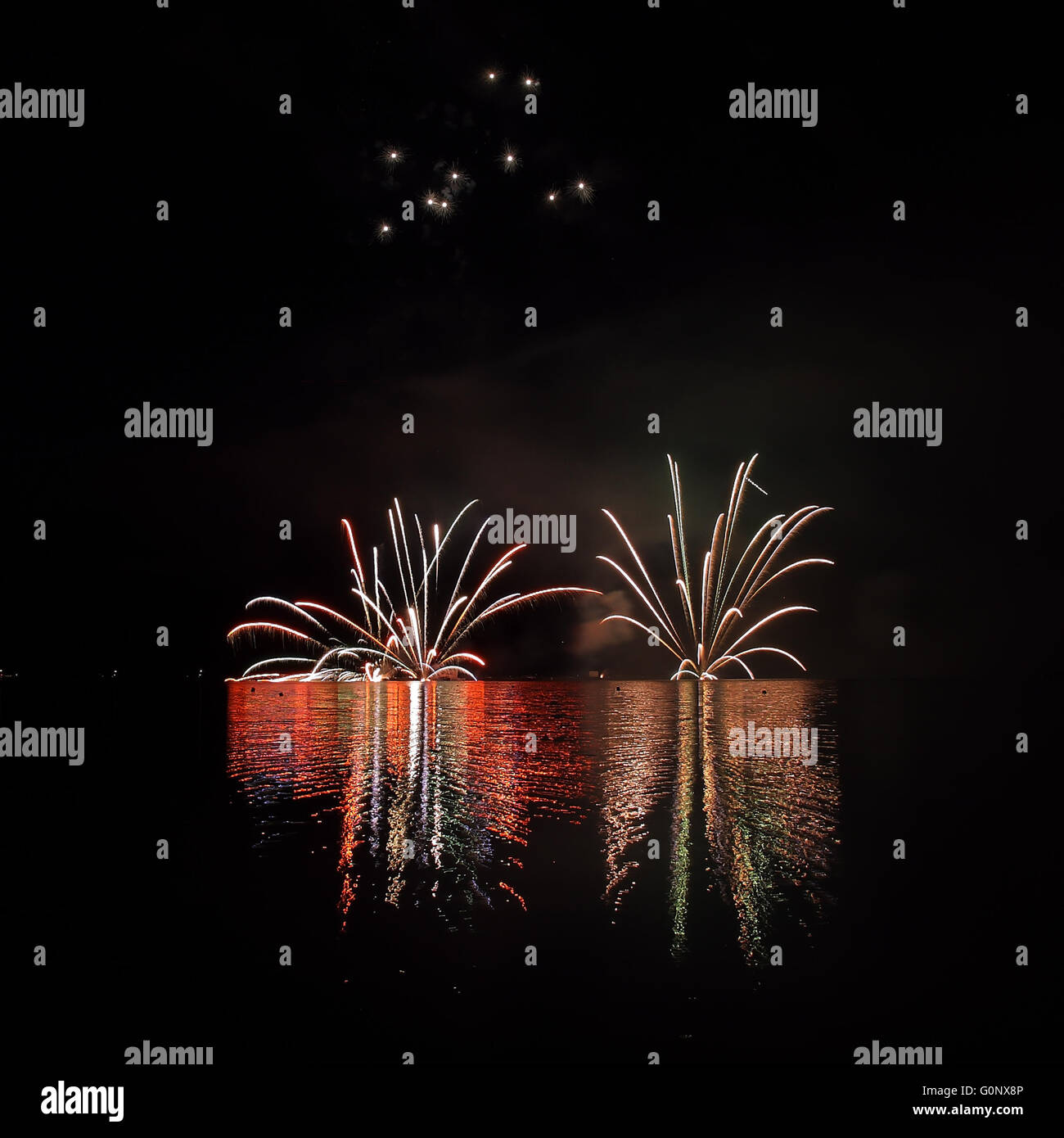 Colorful fireworks with reflection on lake and night sky in background ...