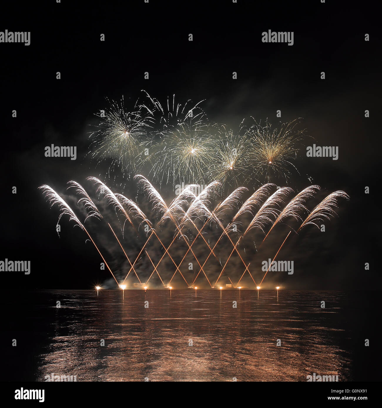 Colorful fireworks with reflection on lake and night sky in background ...