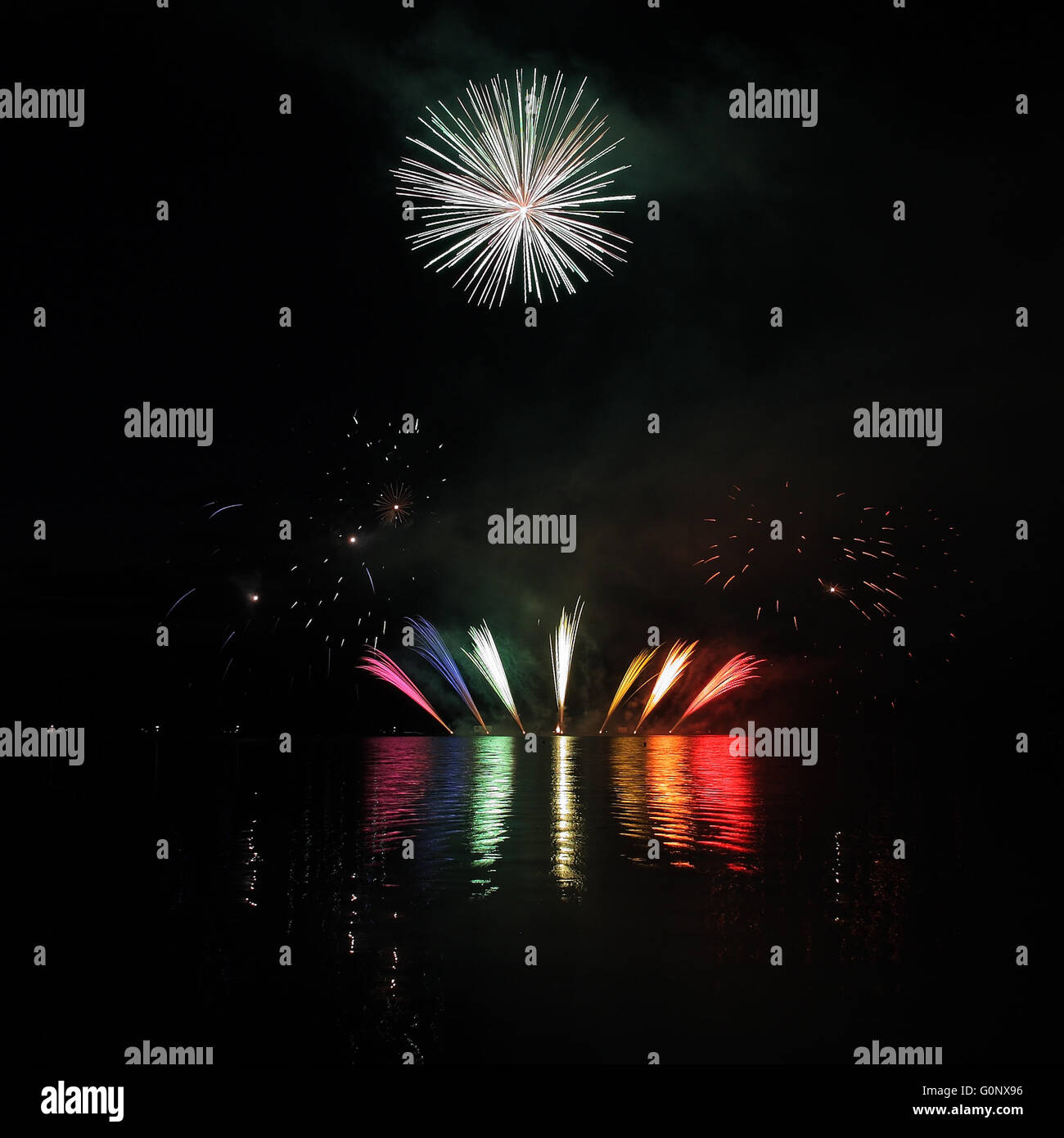 Colorful fireworks with reflection on lake and night sky in background ...