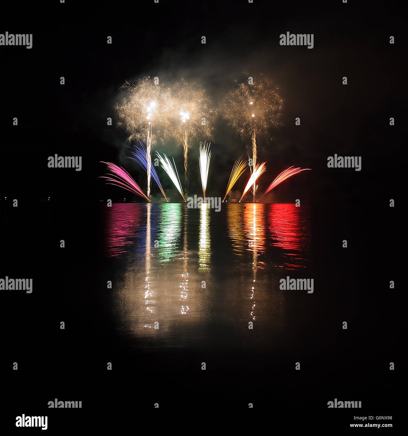 Colorful fireworks with reflection on lake and night sky in background ...
