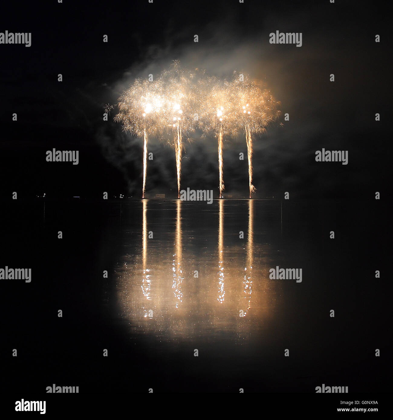 Colorful fireworks with reflection on lake and night sky in background ...