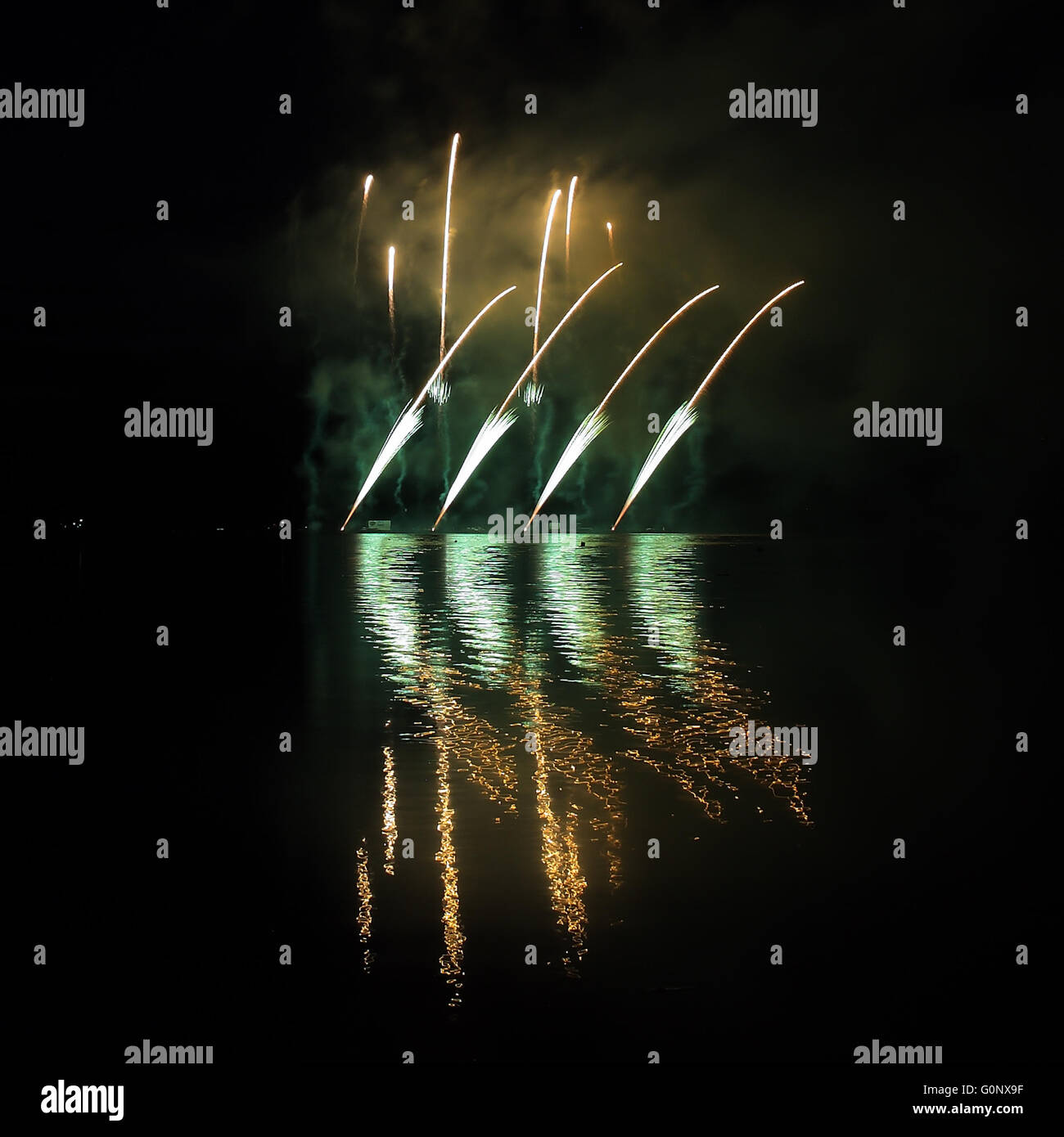Colorful fireworks with reflection on lake and night sky in background ...