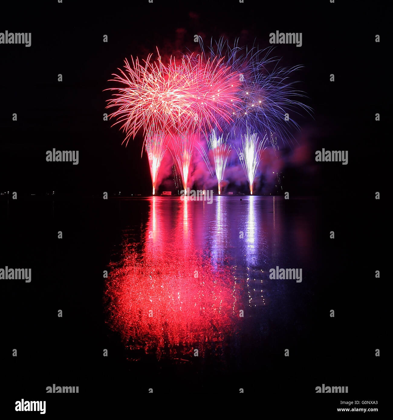 Colorful fireworks with reflection on lake and night sky in background ...