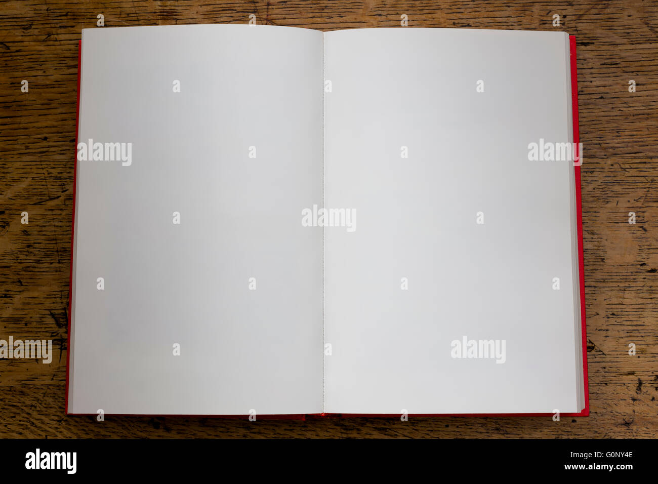 Open red covered book with blank white pages on oak background Stock ...