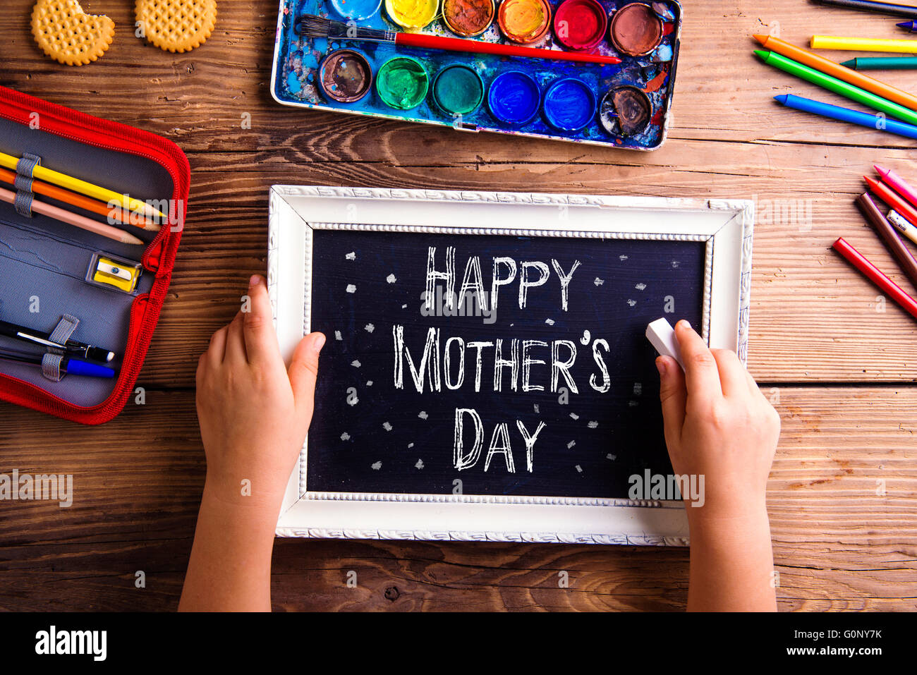 Girl writing with chalk on little board, Mothers day Stock Photo - Alamy