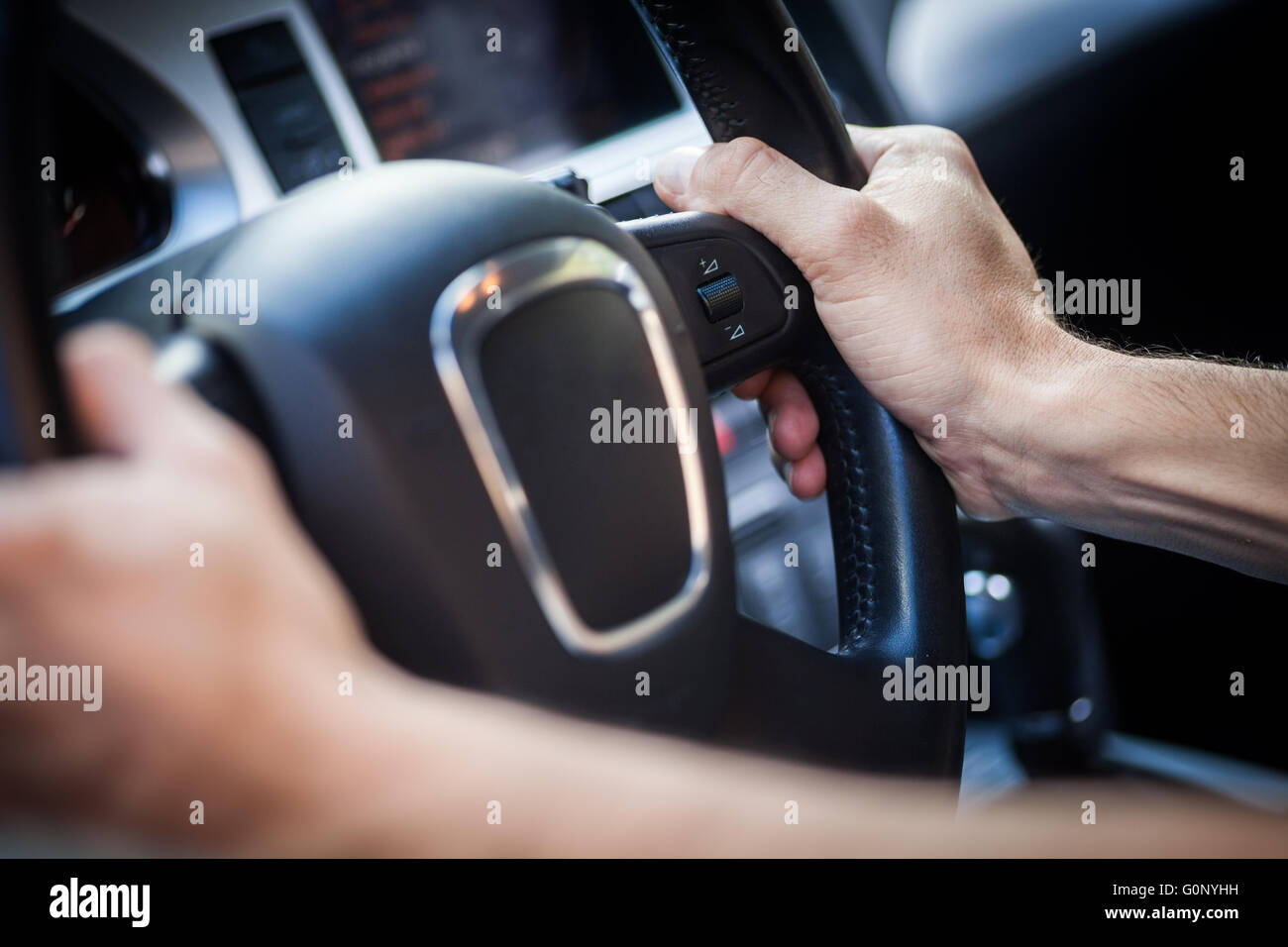 Color image of two hands holding a steering wheel inside a car Stock ...