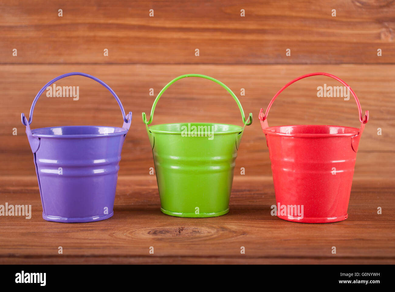 Beautiful buckets on the wooden background Stock Photo - Alamy