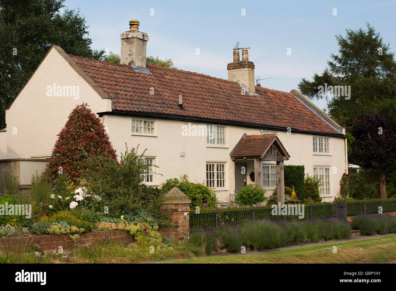 Exterior and front garden of an attractive, whitewashed, traditional ...