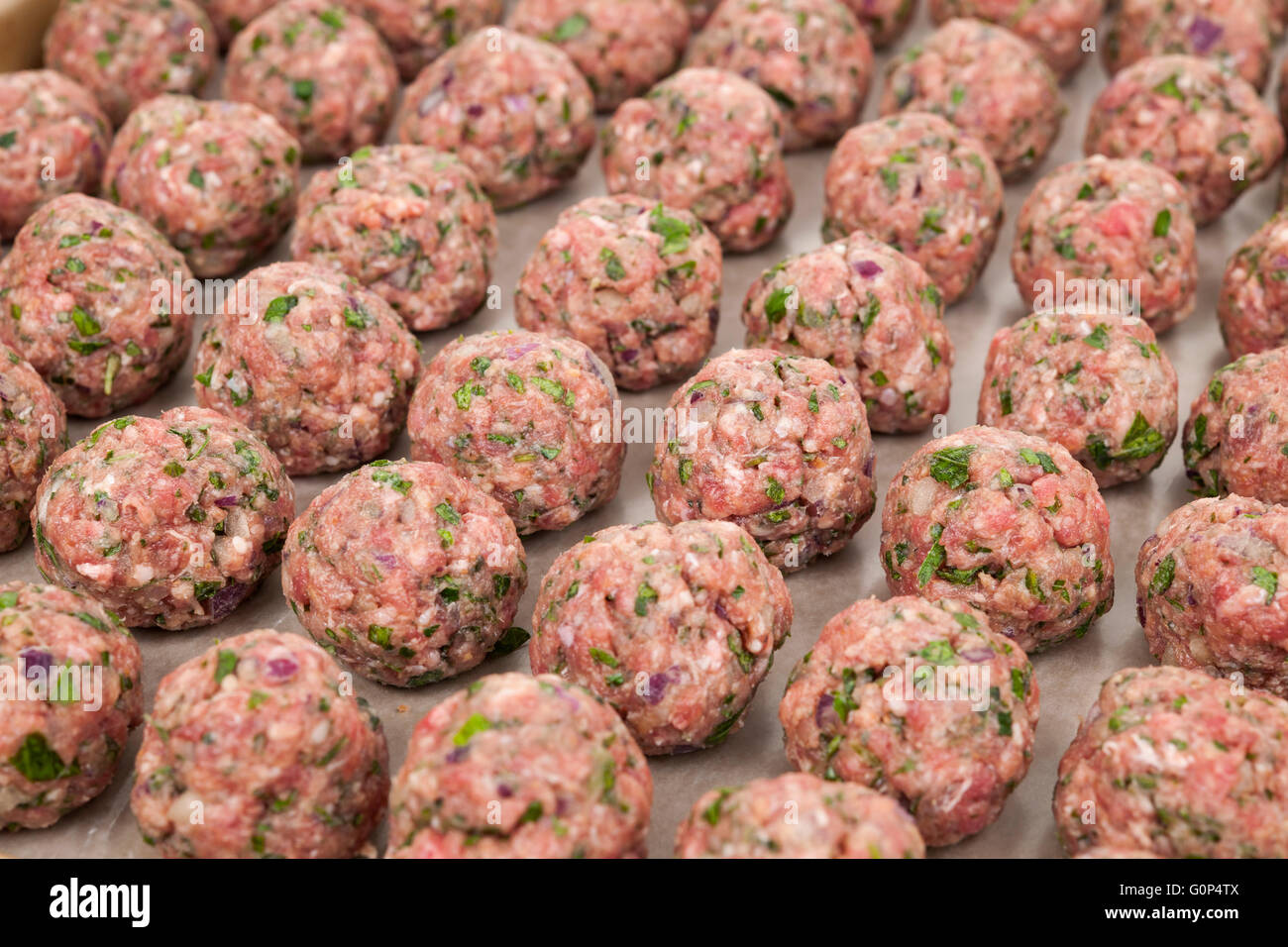 Rows of raw homemade meatballs prepared for cooking on a tray Stock ...