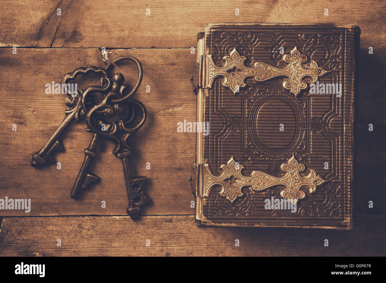 top view of antique book cover, with brass clasps and old keys. sepia ...