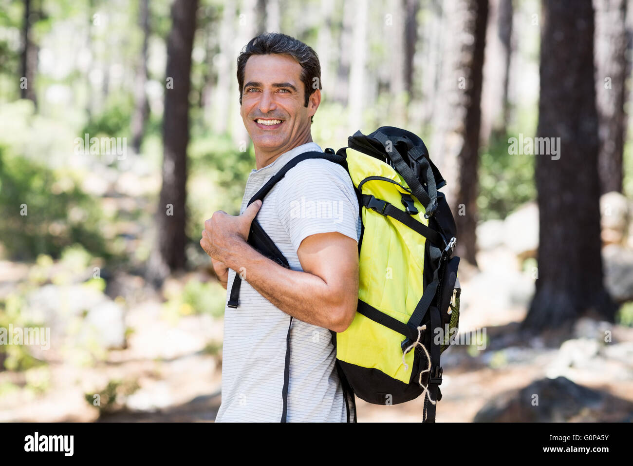 Man smiling and posing with his backpack Stock Photo - Alamy