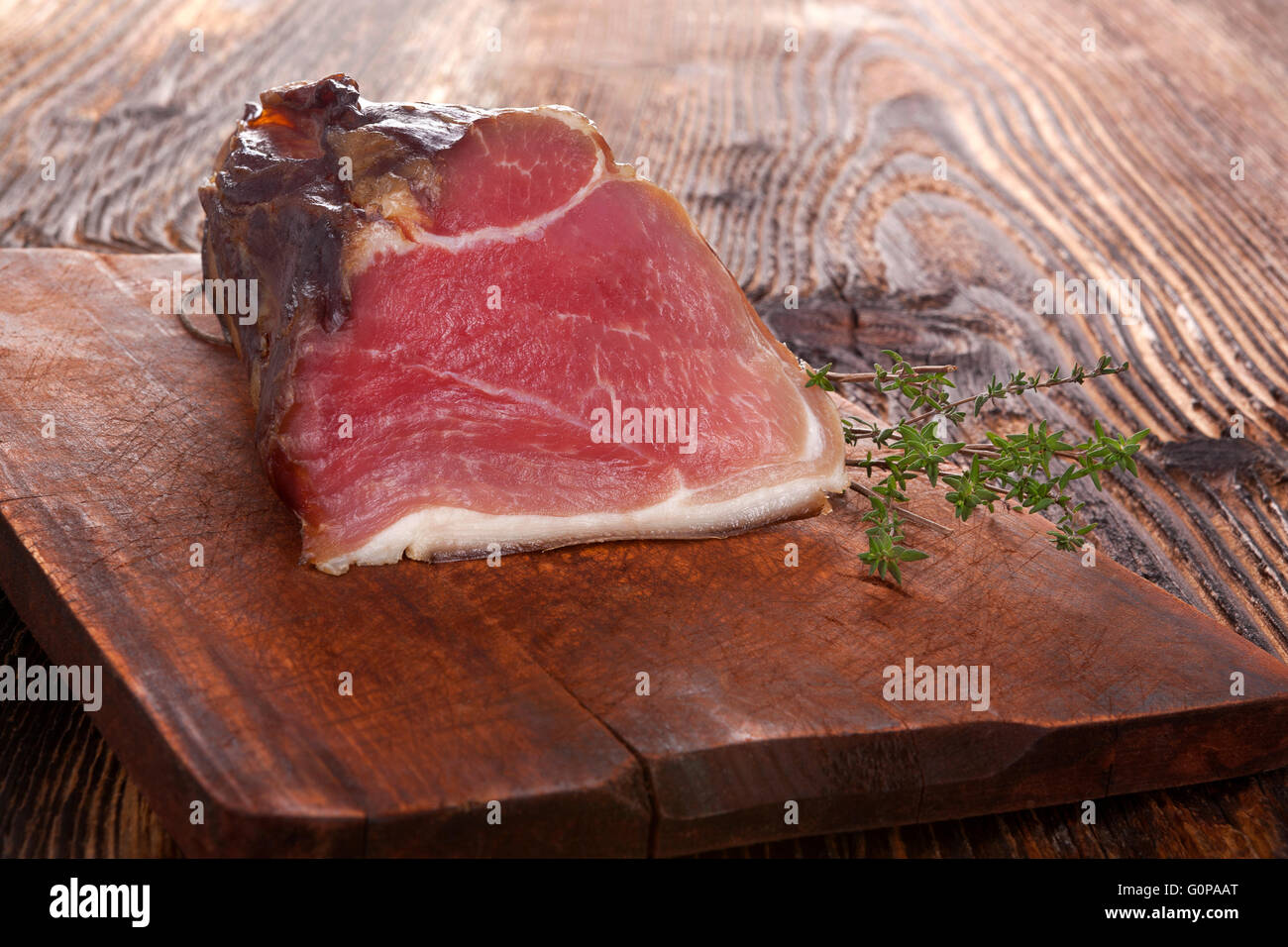 Traditional smoked meat on wooden table. Culinary meat eating Stock ...