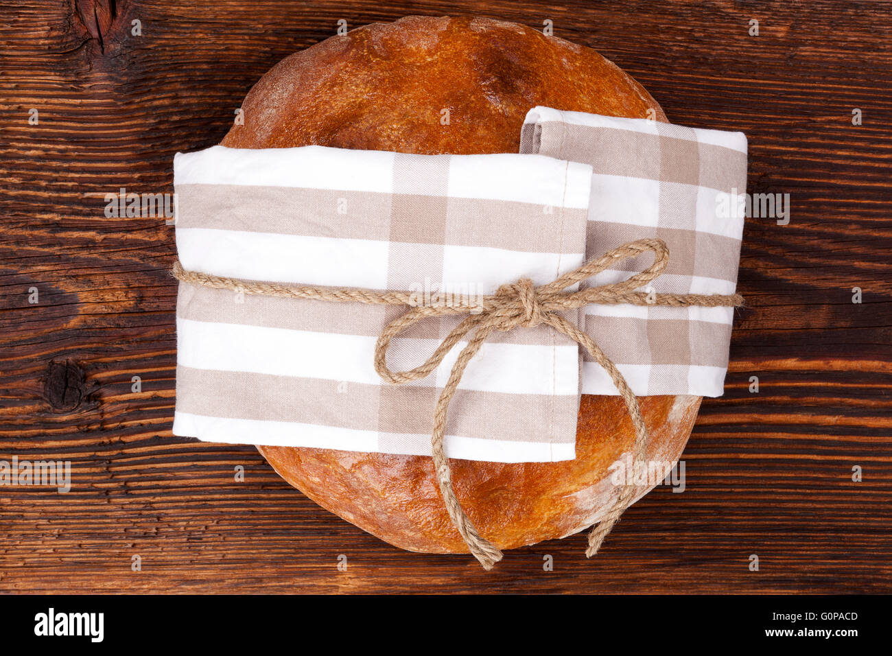 Delicious round bread loaf on wooden table, top view. Culinary bread ...