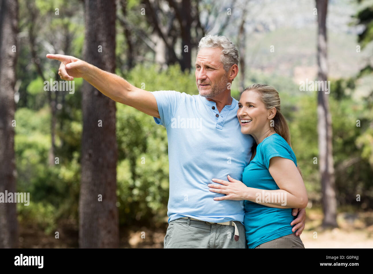 Couple pointing and holding each other Stock Photo - Alamy