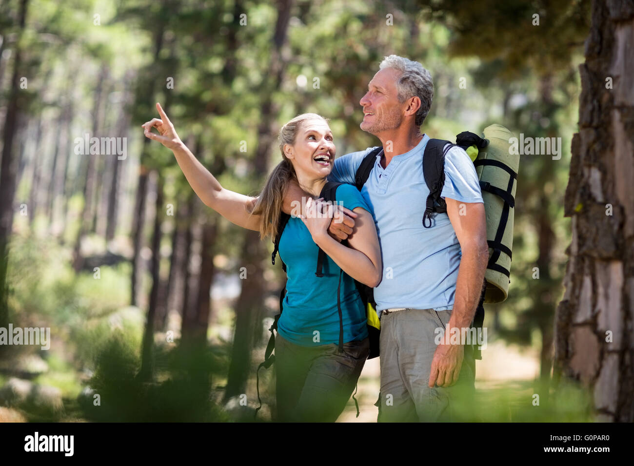 Couple pointing and holding each other Stock Photo - Alamy