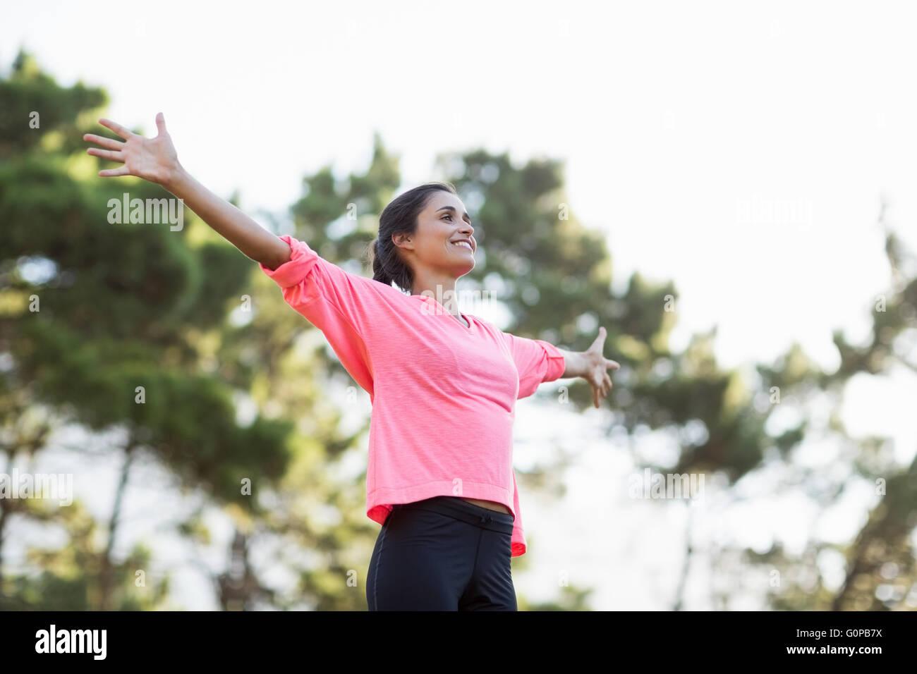 Woman smiling and throwing arms Stock Photo - Alamy