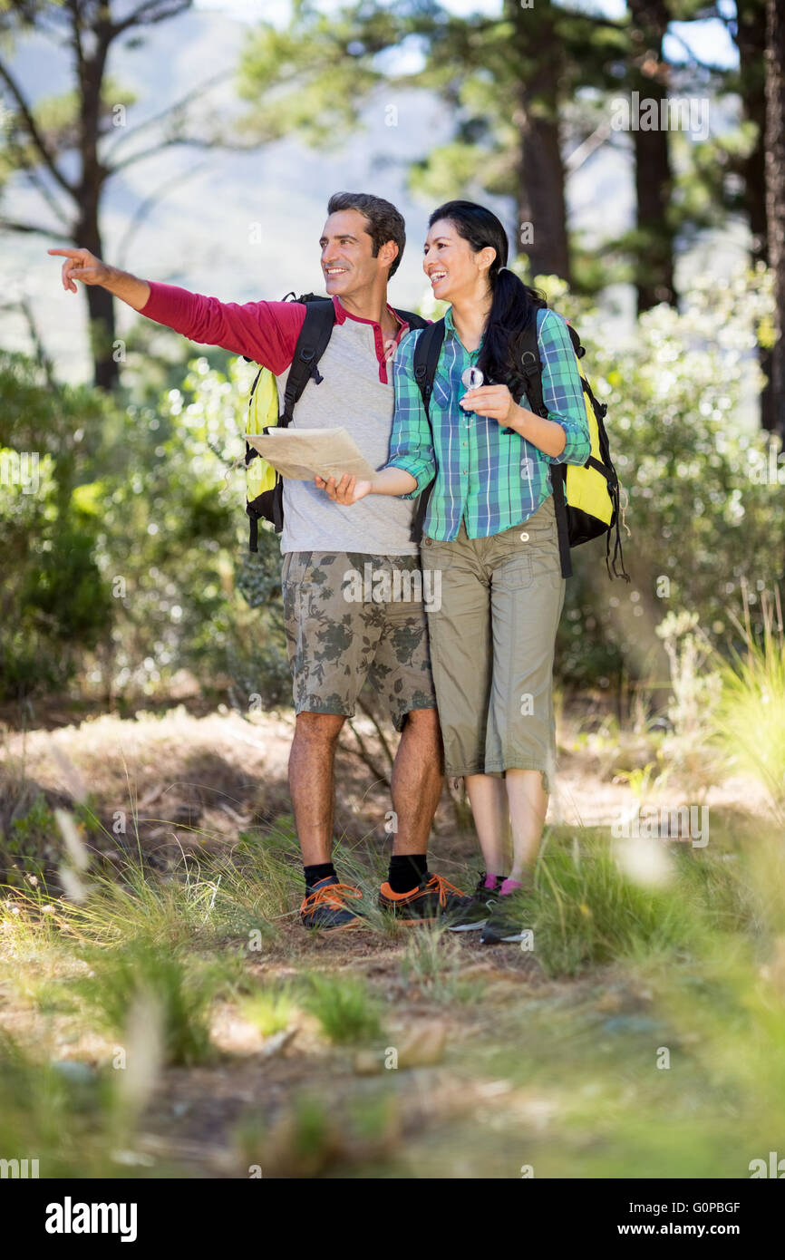 Couple pointing and holding a map Stock Photo - Alamy