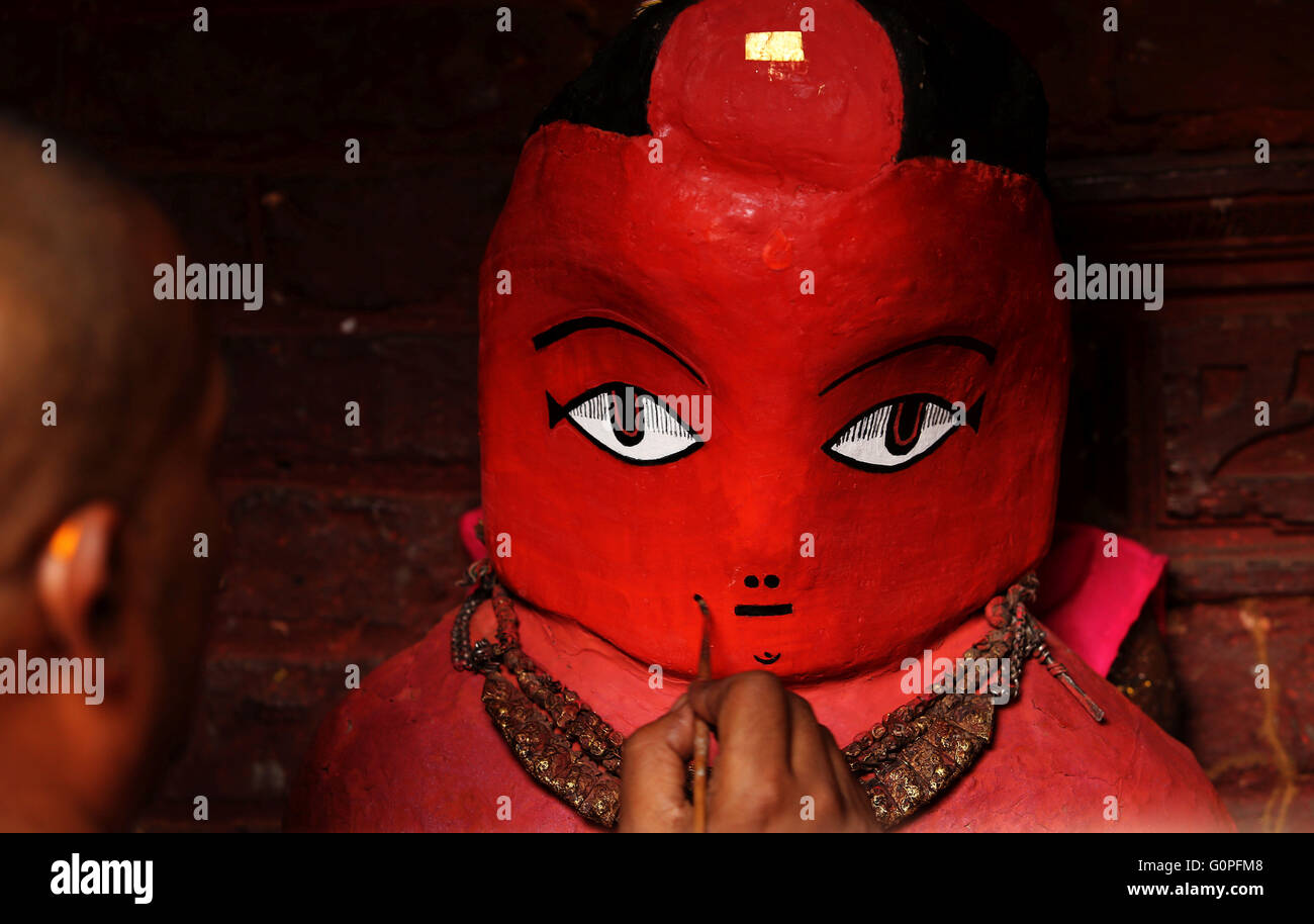 Lalitpur, Nepal. 3rd May, 2016. A priest decorates the idol of Rato ...