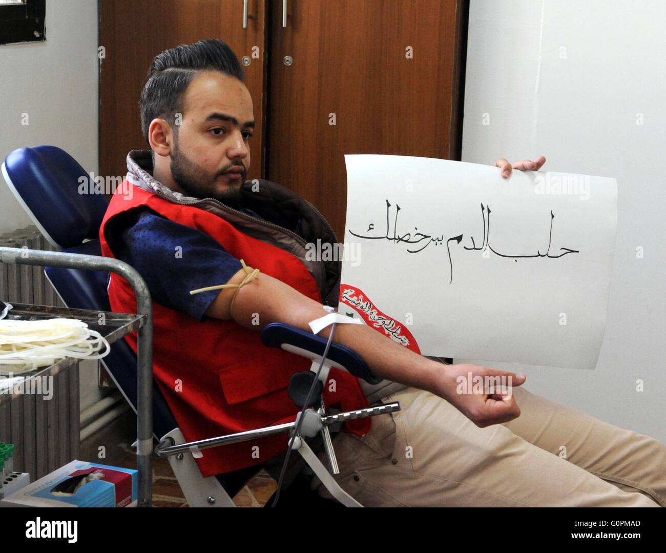 Damascus, Syria. 3rd May, 2016. A Syrian university student donates ...