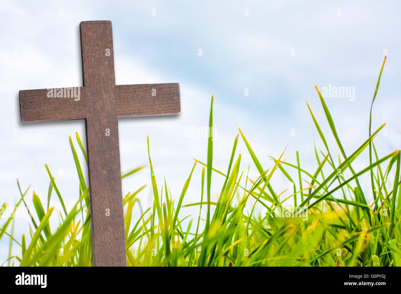The Cross of Jesus Christ and green grass with sky Stock Photo - Alamy