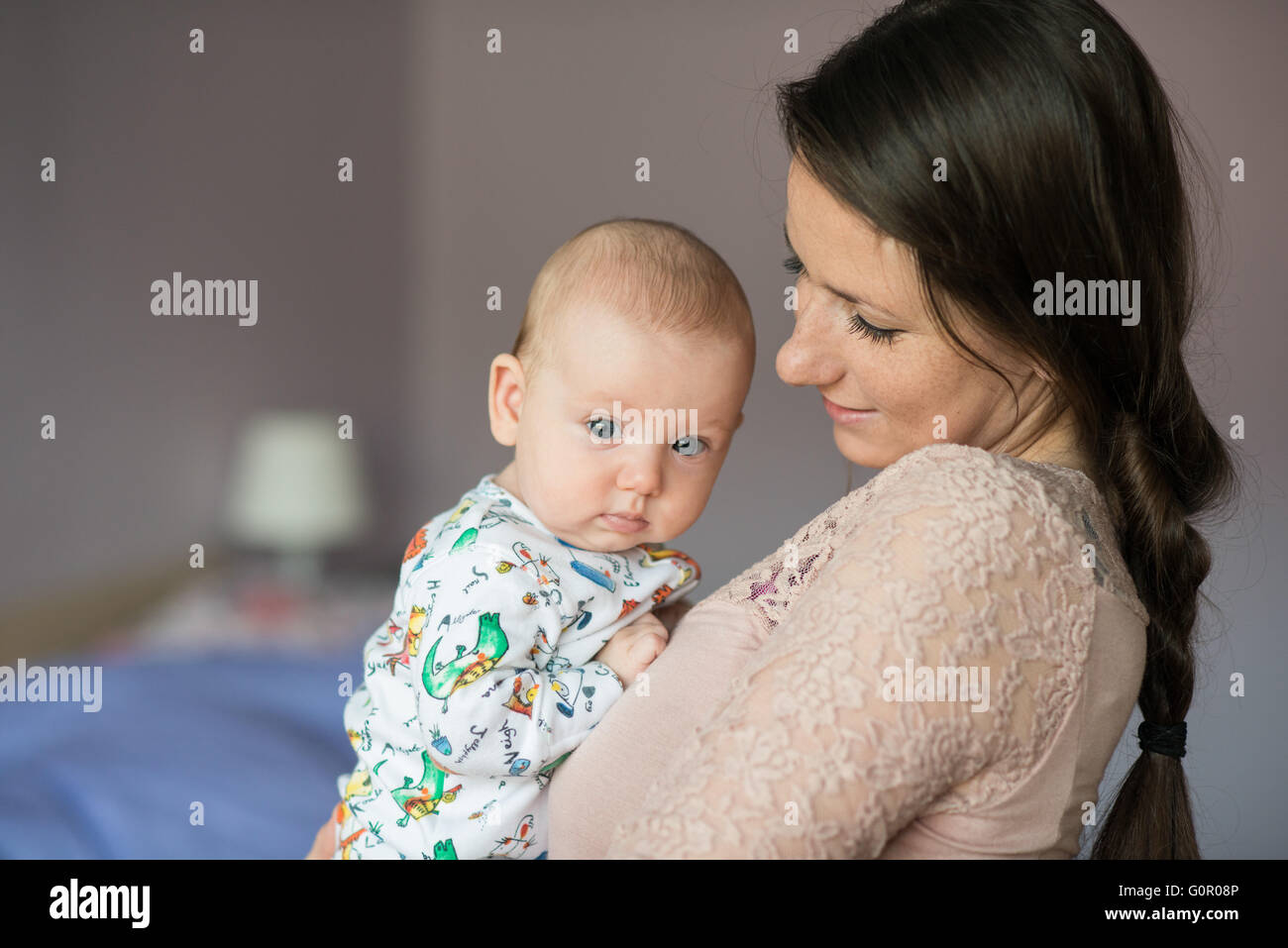 Young mother holding her cute baby daughter Stock Photo - Alamy