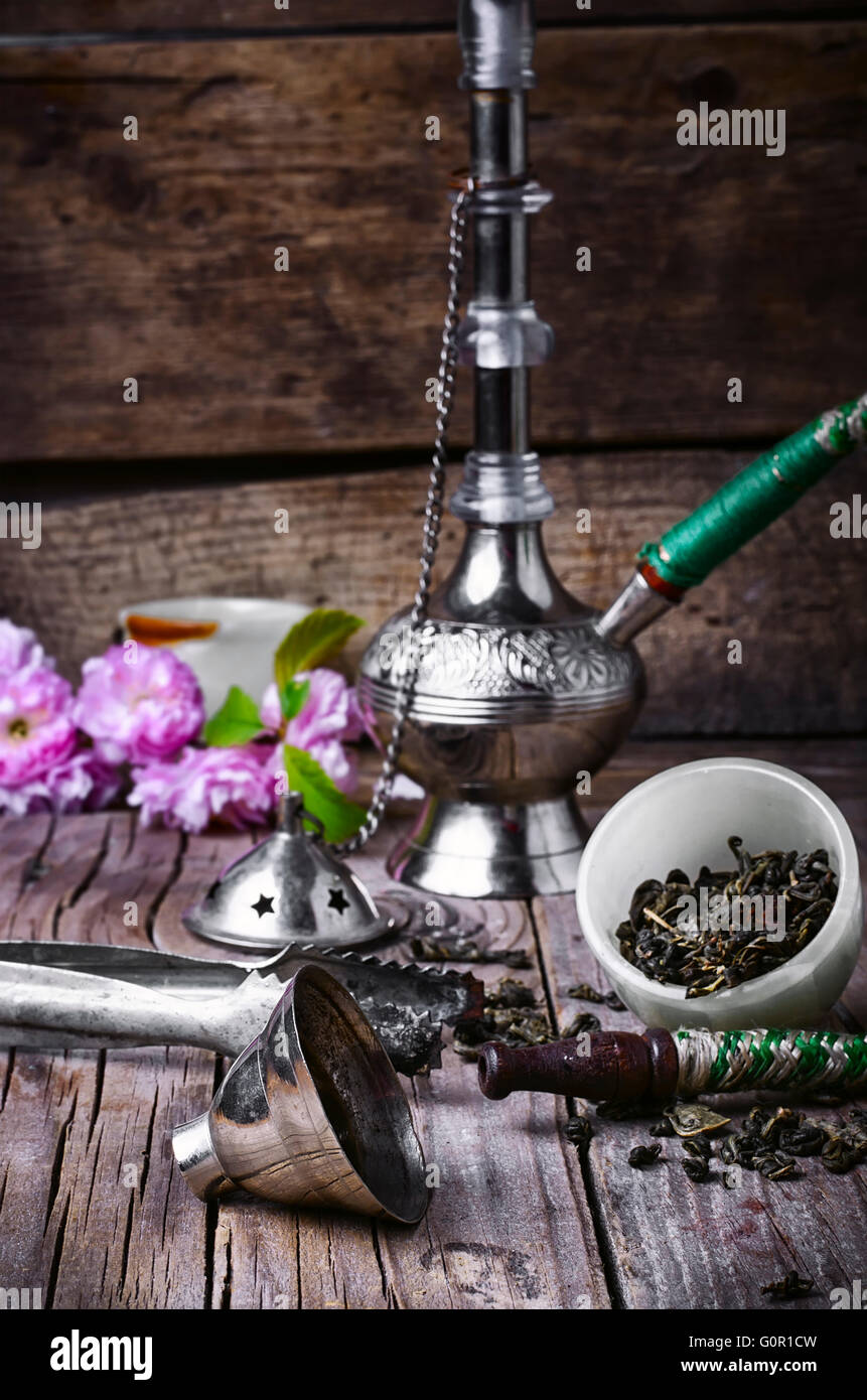 Arab hookah metal and scattered tobacco leaf Stock Photo - Alamy