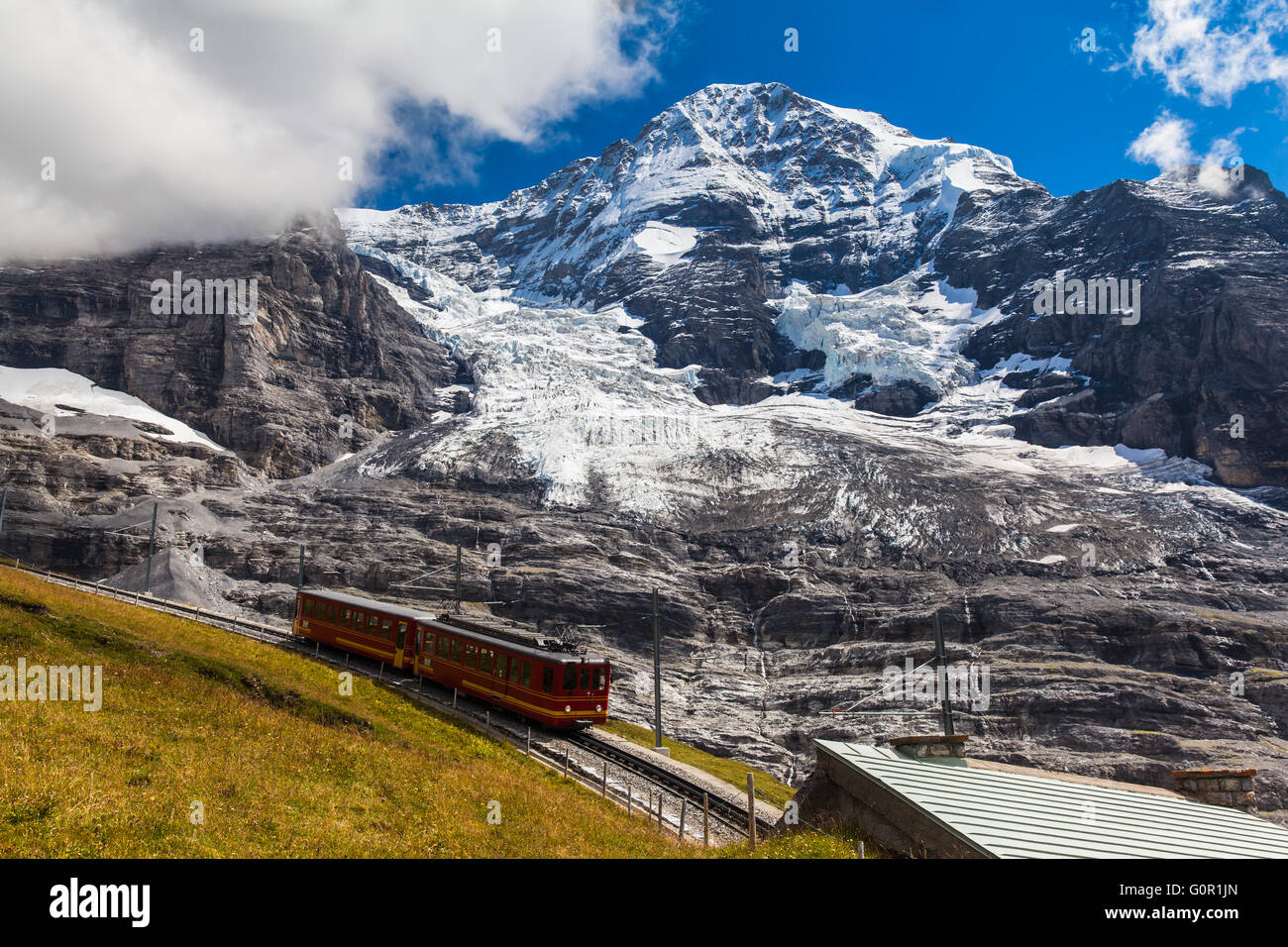 Train of Jungfraubahn running towards Jungfraujoch under the Monch and ...