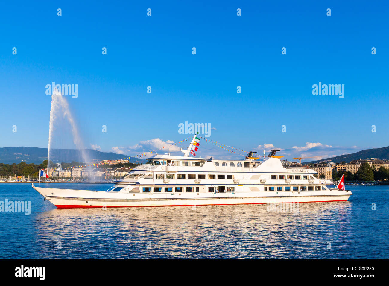 Cruise ship on the lake of Geneva in the sunshine at dusk, with the ...