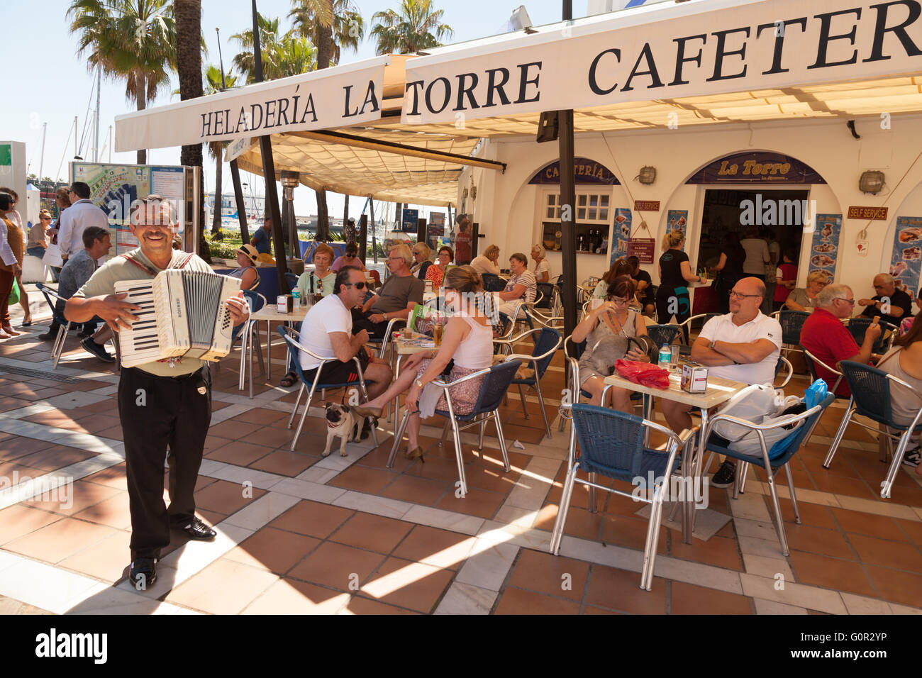 Local people and holidaymakers relaxing at a cafe, Estepona, Costa del ...