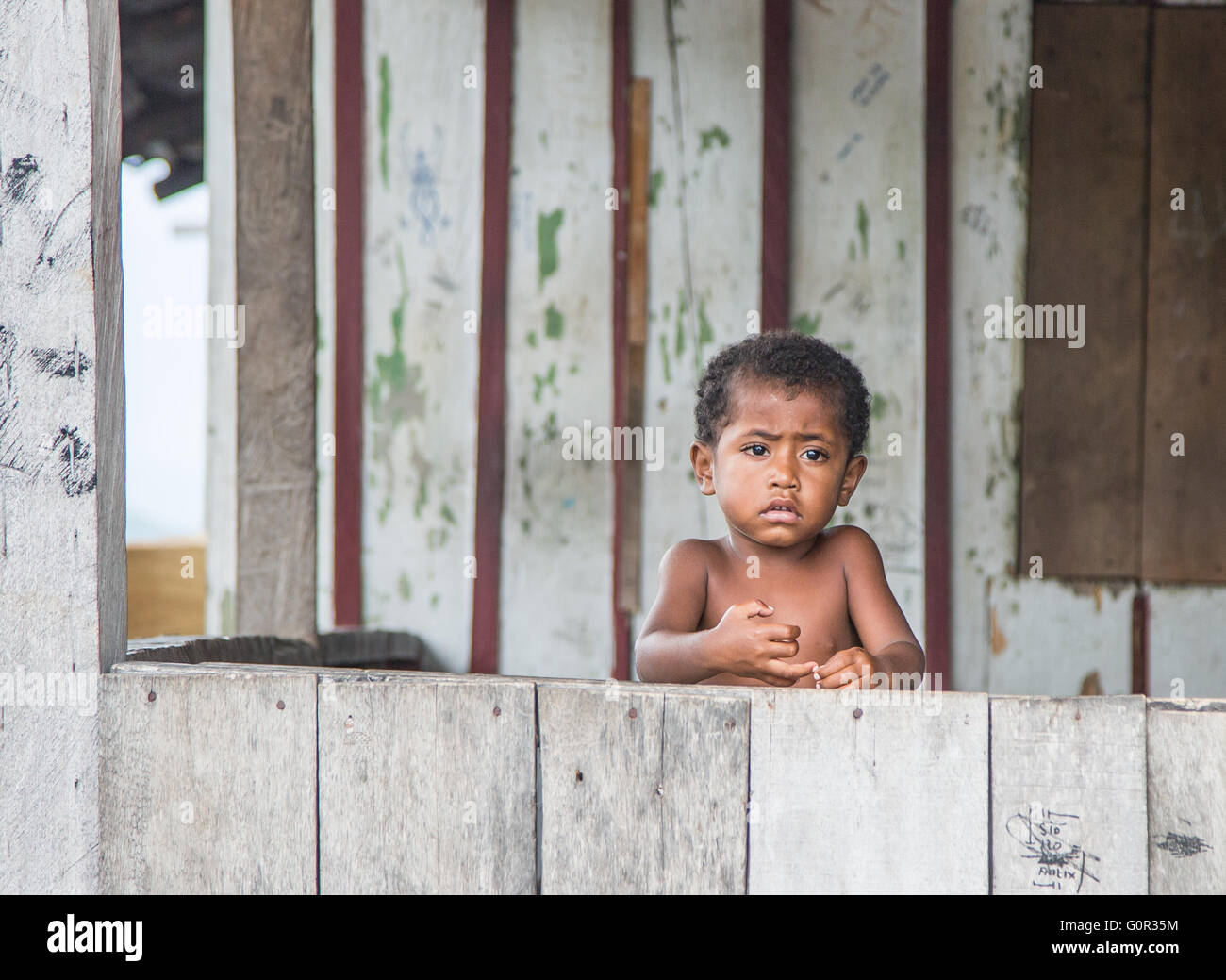 small Papuan boy with a sad face Stock Photo - Alamy