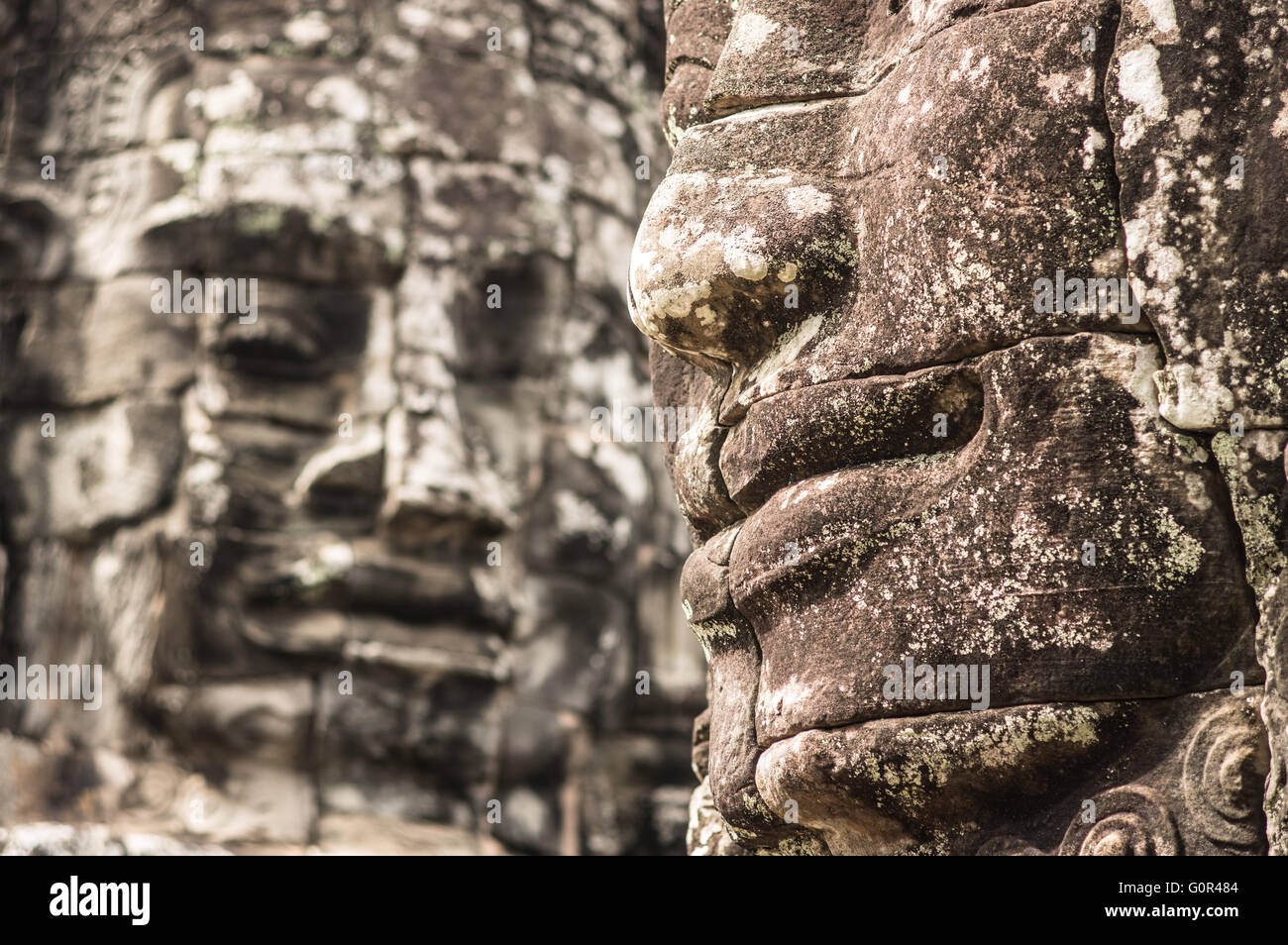 Smiling stone faces in Angkor Wat Stock Photo - Alamy