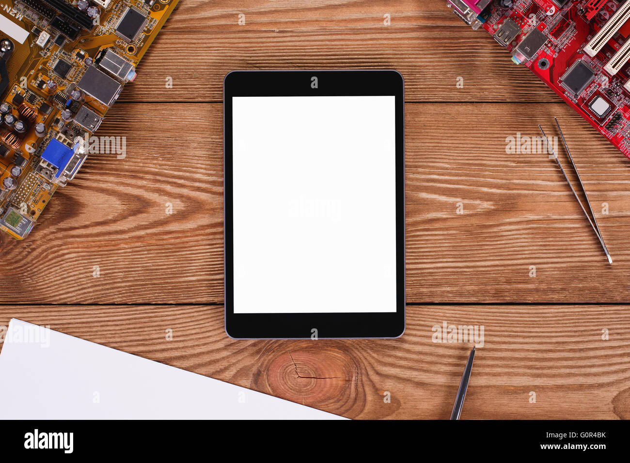 Black modern generic tablet with blank screen on wooden office desk ...