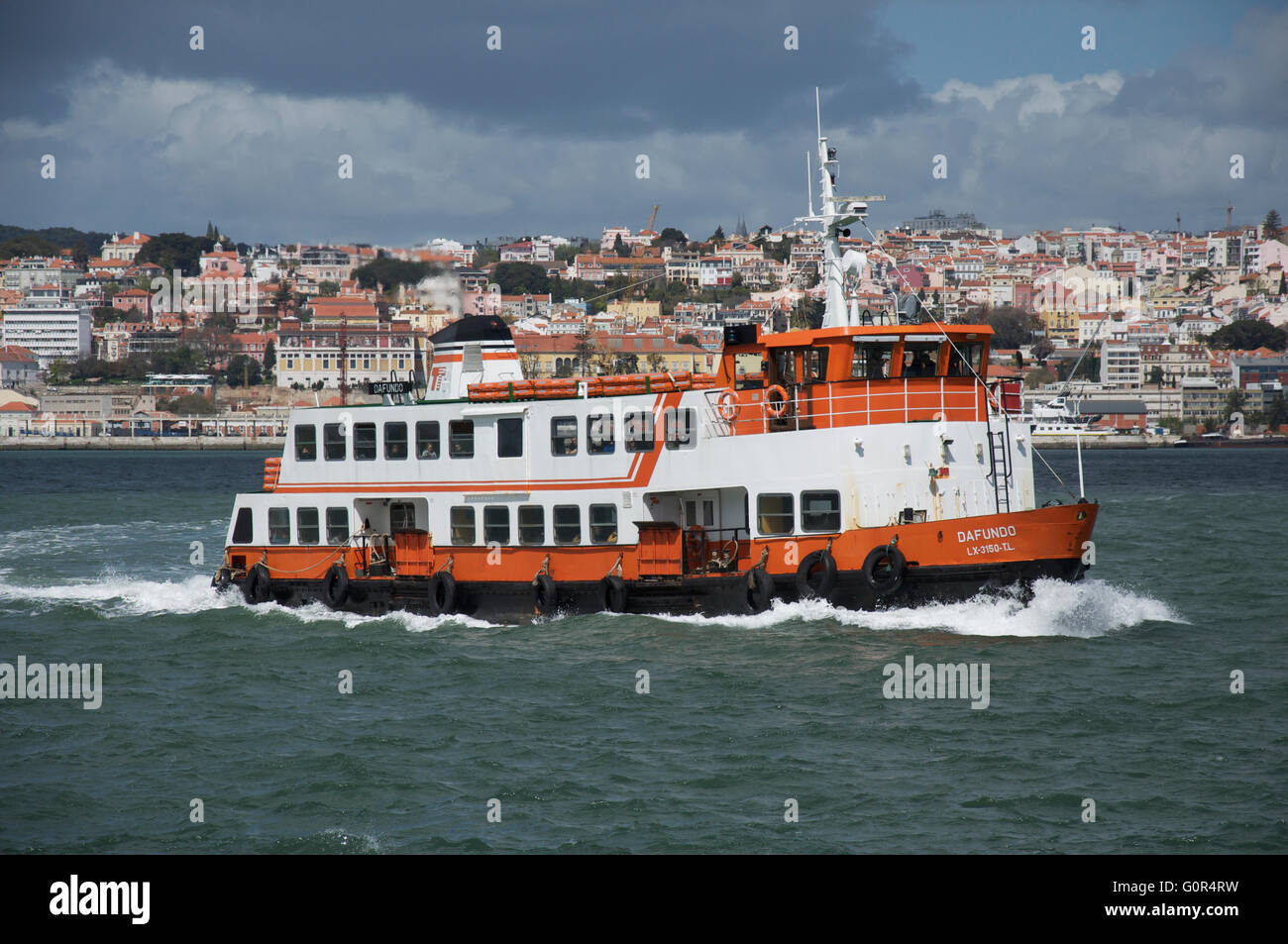 Passenger ferry boat Dafundo carries commuters across the river Tagus ...