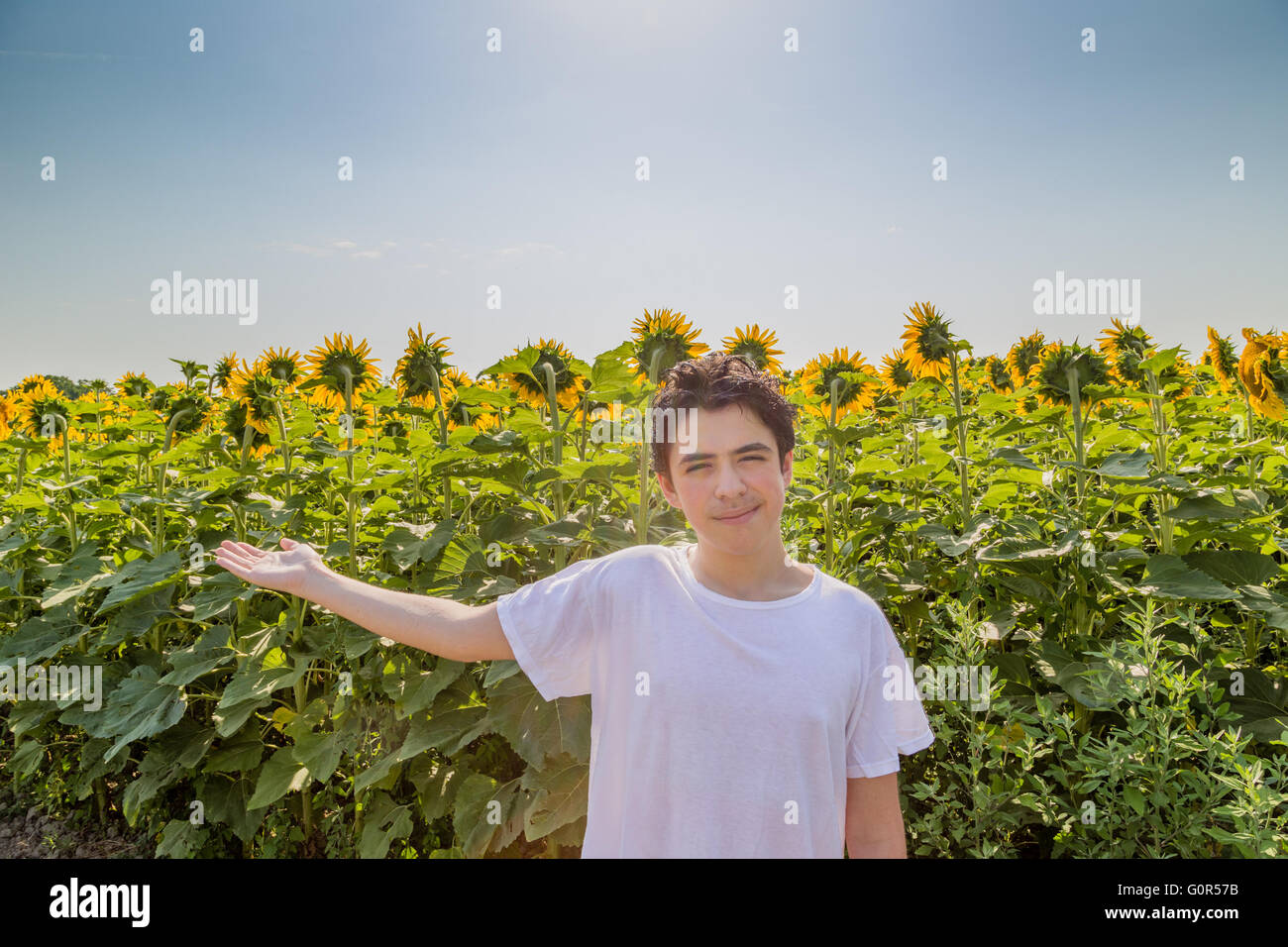 Open air and open arms, Caucasian boy is pointing with right arm in ...