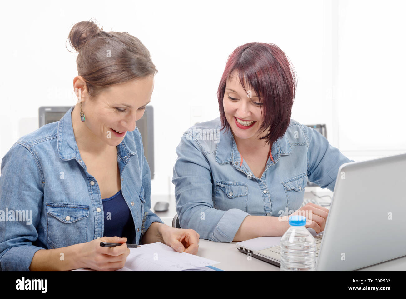 two young women college working on a laptop computer Stock Photo - Alamy
