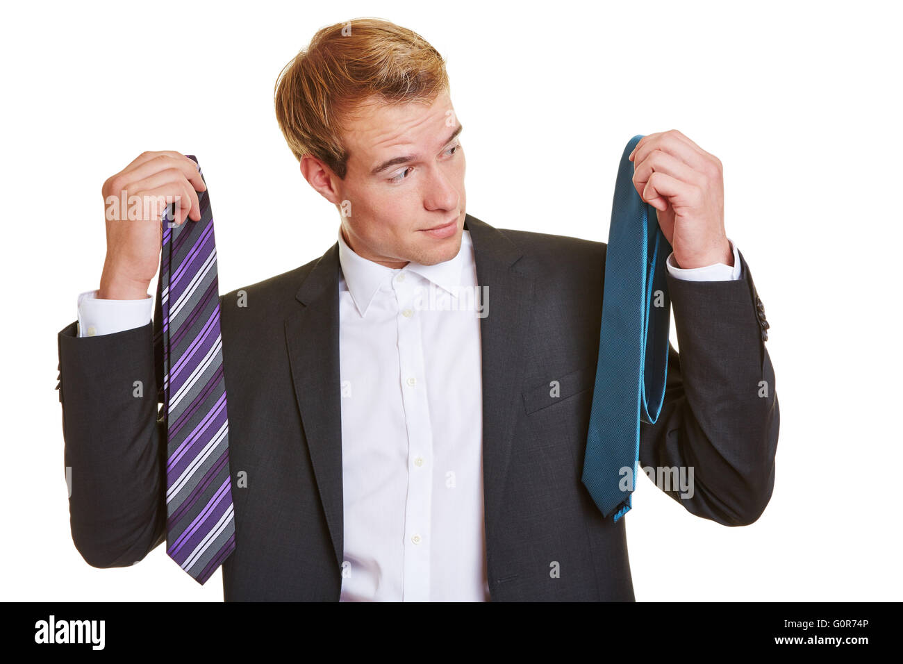 Business man deciding for tie and looking uncertain Stock Photo - Alamy