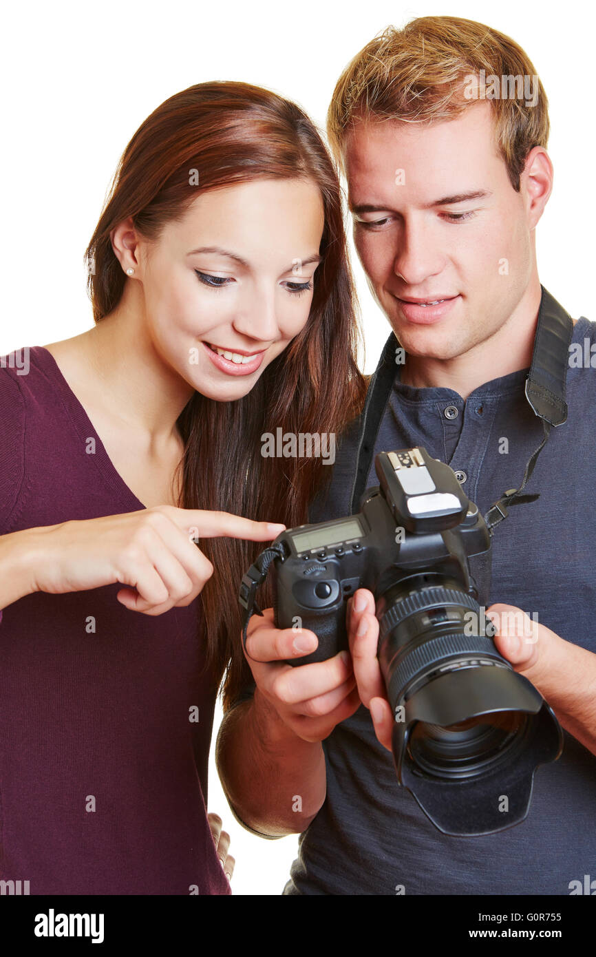Model and photographer checking their new images in the camera display ...