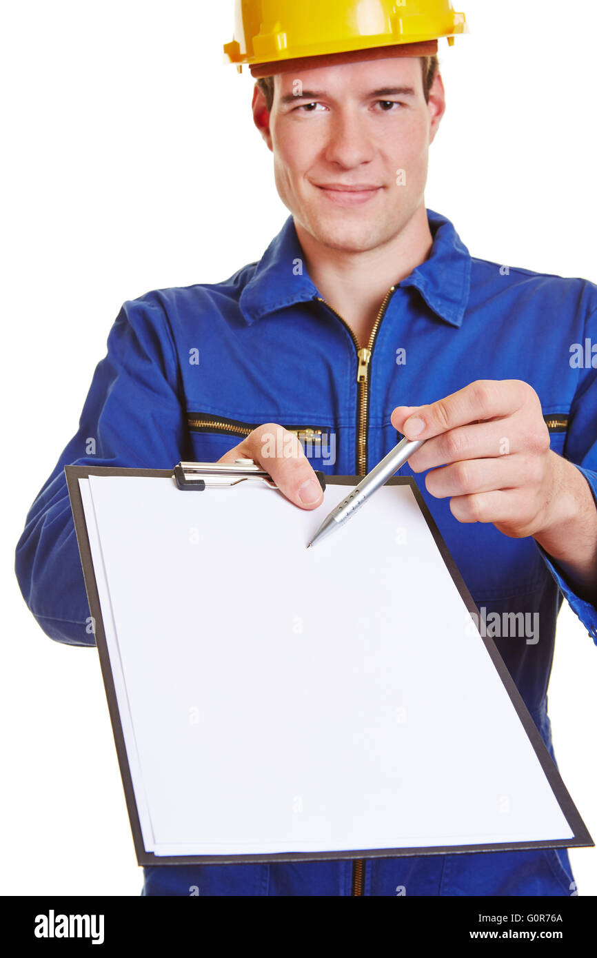 Construction worker holding pen and clipboard ready for a signature ...